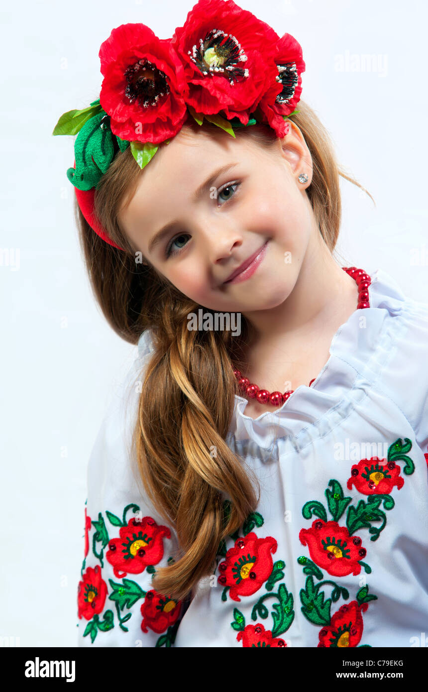 Young pretty girl in a ukrainian national costume on a light background ...