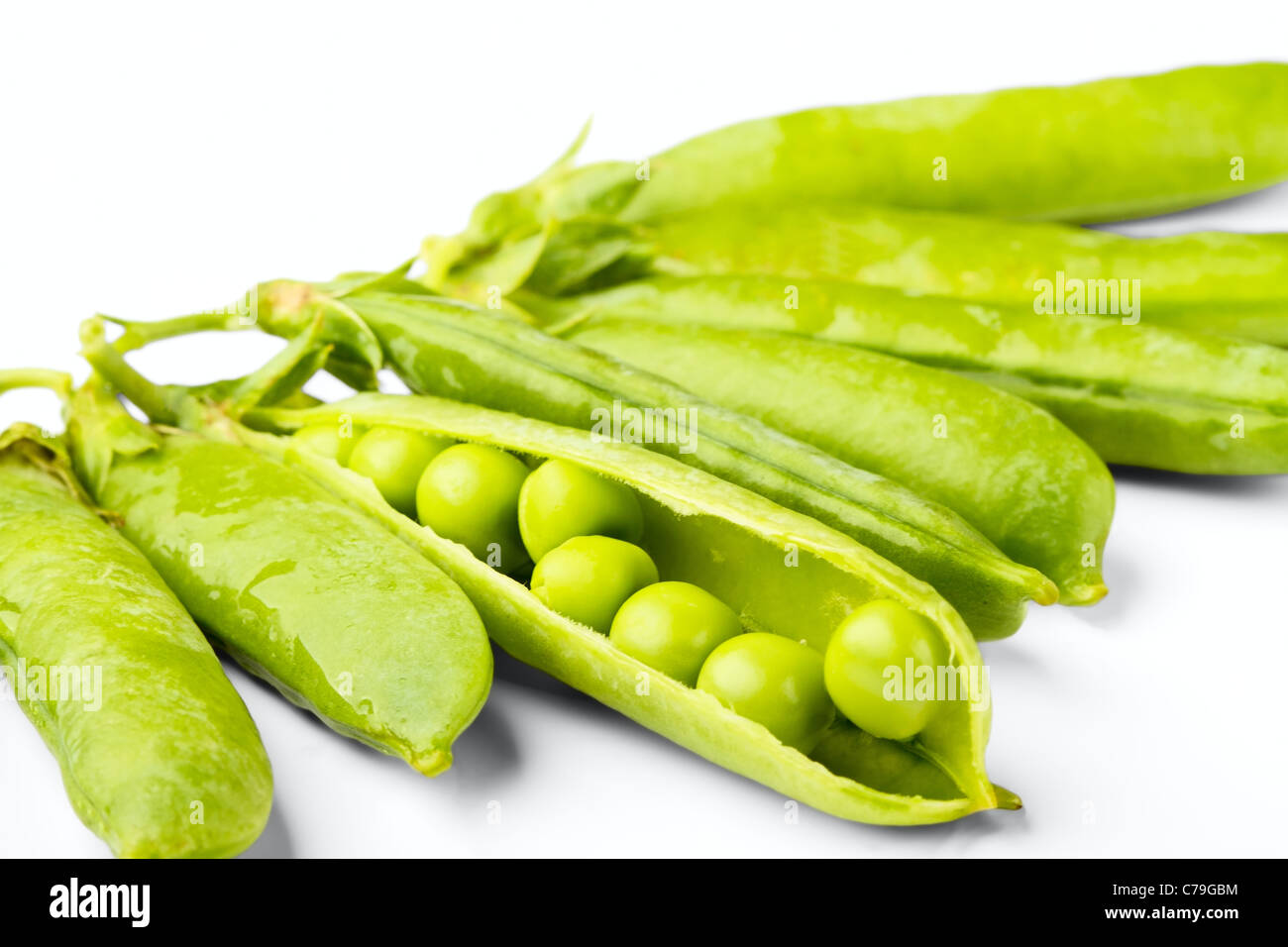 Green peas isolated on a white background Stock Photo - Alamy