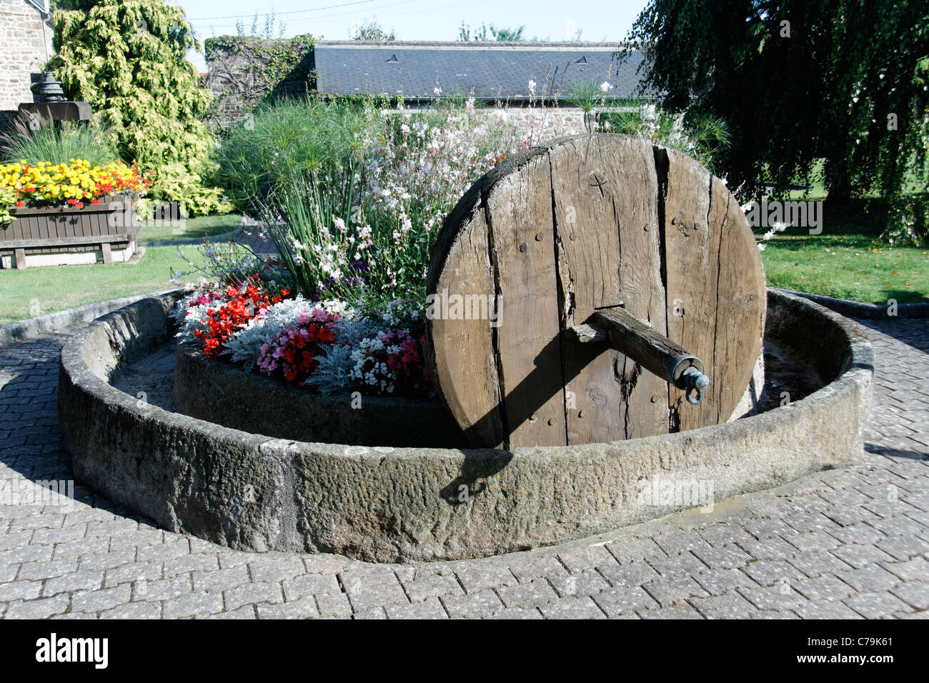 An old stone cider apple mill with a wooded wheel, Ducey (Manche ...