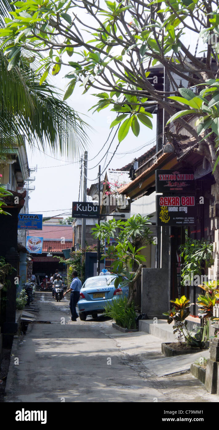 Hotels guest houses and businesses line narrow lanes behind Kuta Beach ...