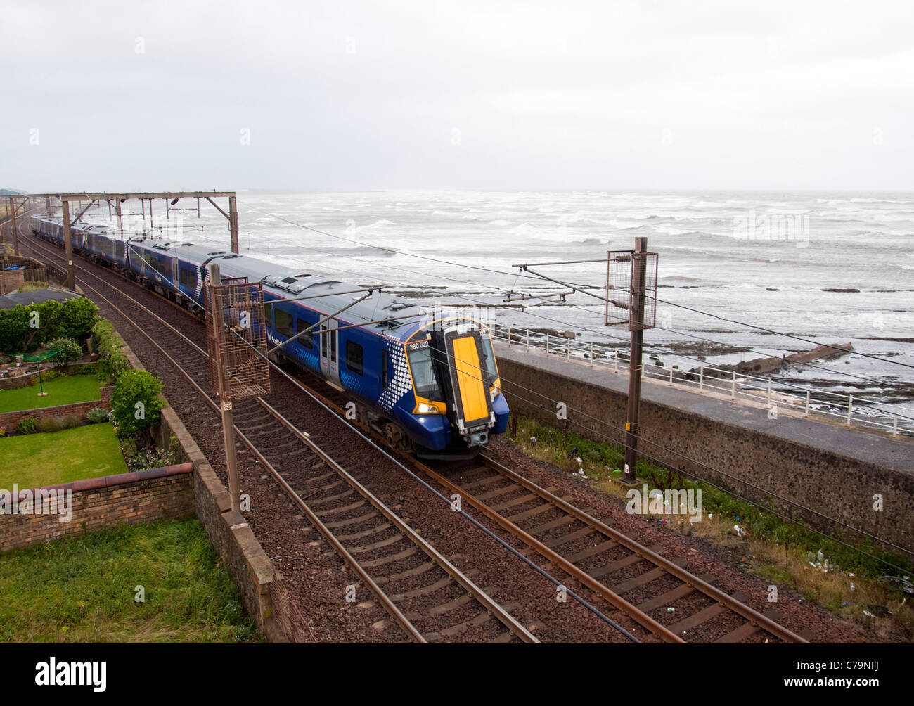 A British Rail Class 380 Train Approaching Saltcoats With A Stormy Sea In The Background Stock 