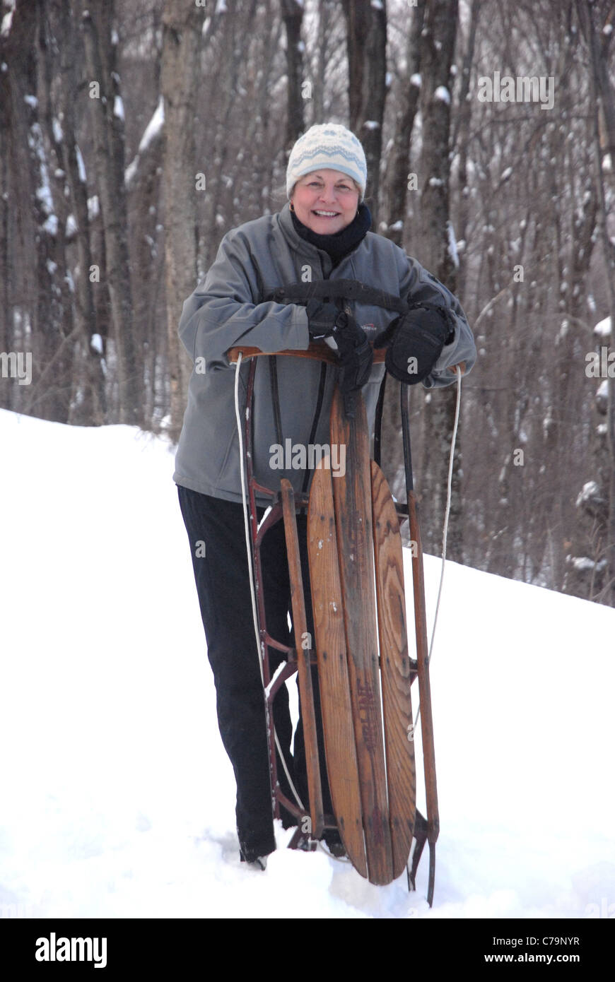 A woman poses with her sled as she prepares to go sledding on closed ...
