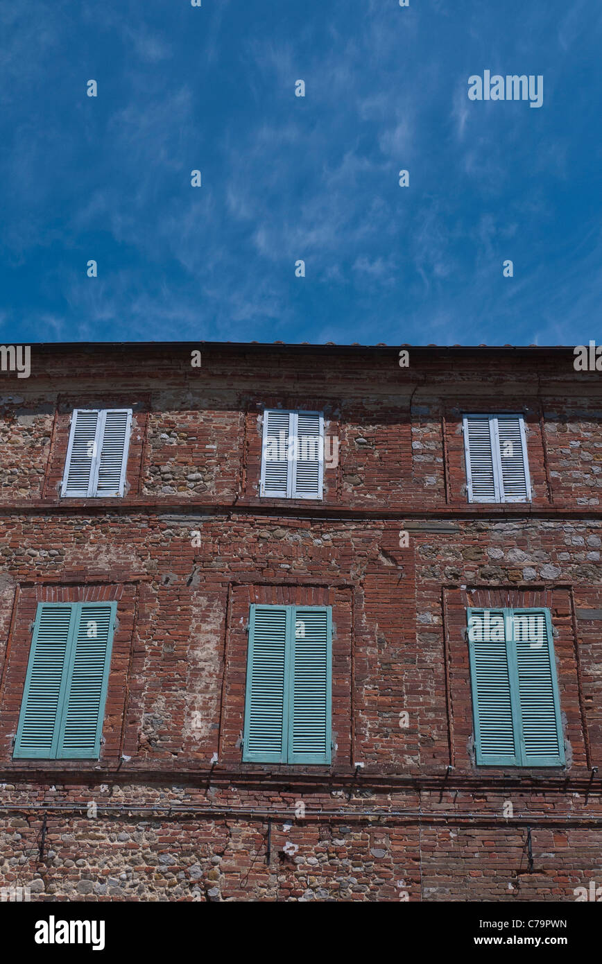 Architectural detail looking up at the side of an old brick building ...