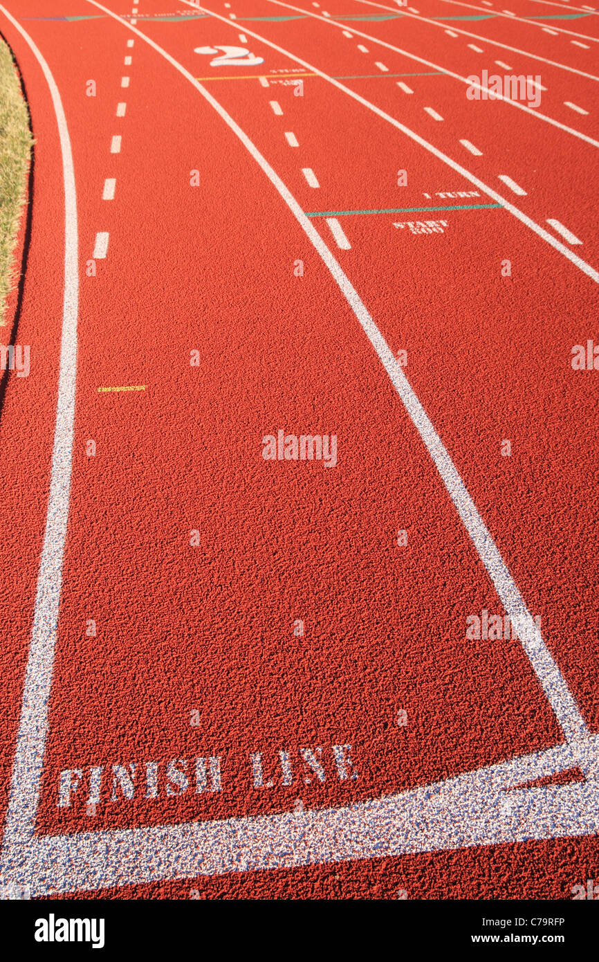 the finish line and start of the turn on a red rubber track Stock Photo ...