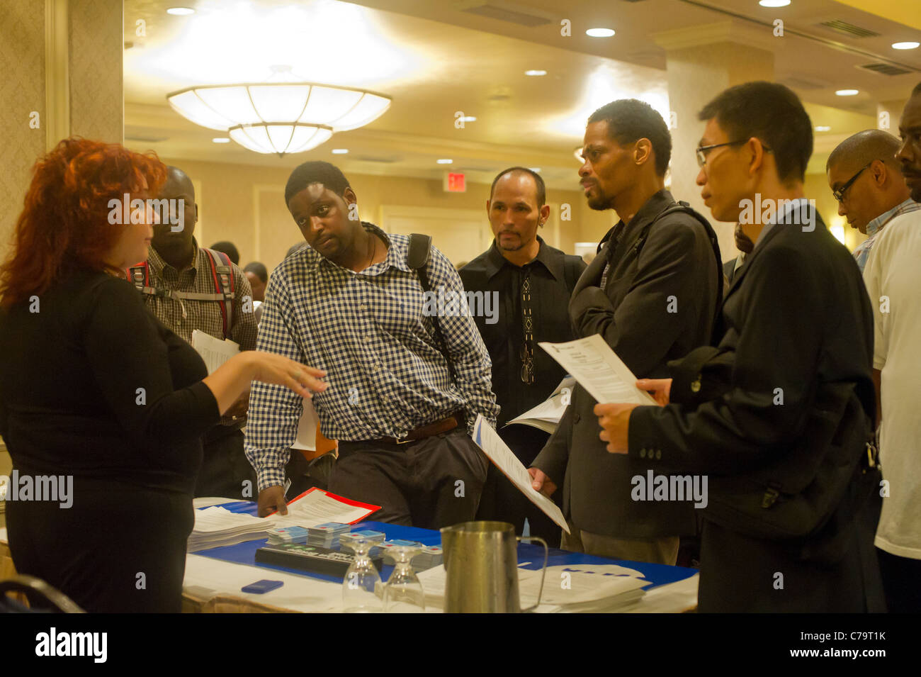 Job seekers attend a job fair in midtown in New York on Thursday ...