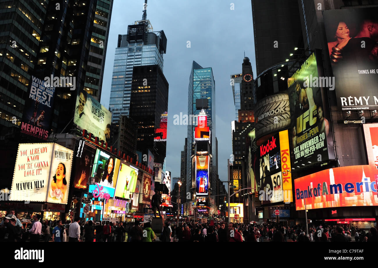 Evening twilight view, towards Times Tower, crowds of people, red blue ...