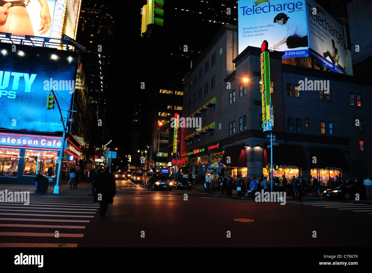 Night-time view Applebee's, blue neon delicatessen cafe, headlights ...