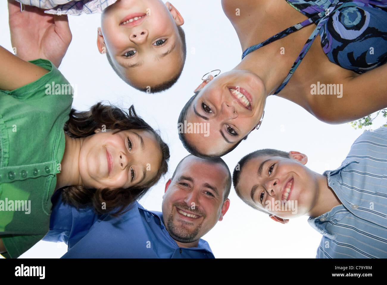 A happy family posing in a group huddle formation Stock Photo - Alamy