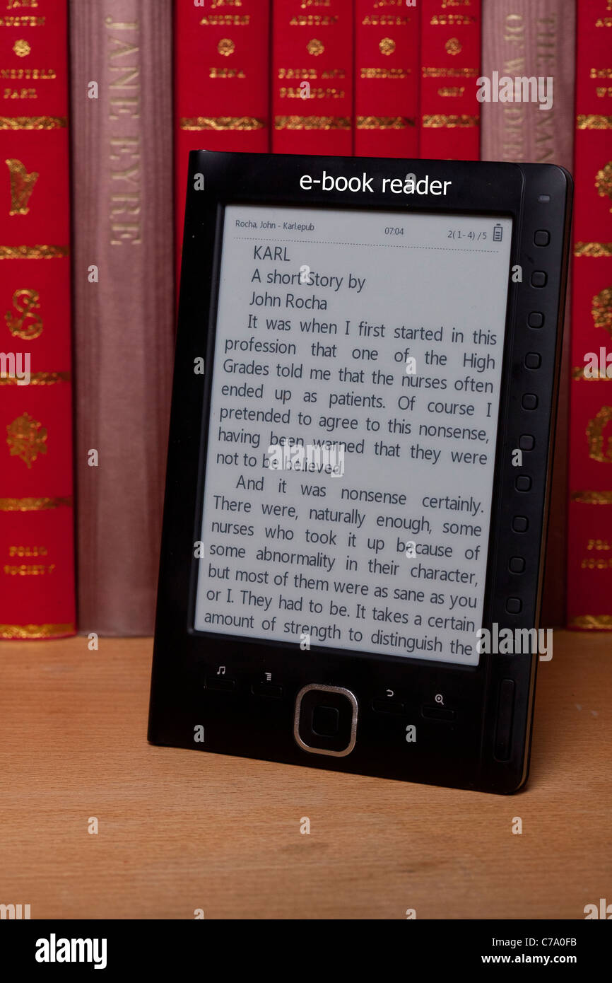 A black e book reader on a shelf with classical books Stock Photo - Alamy