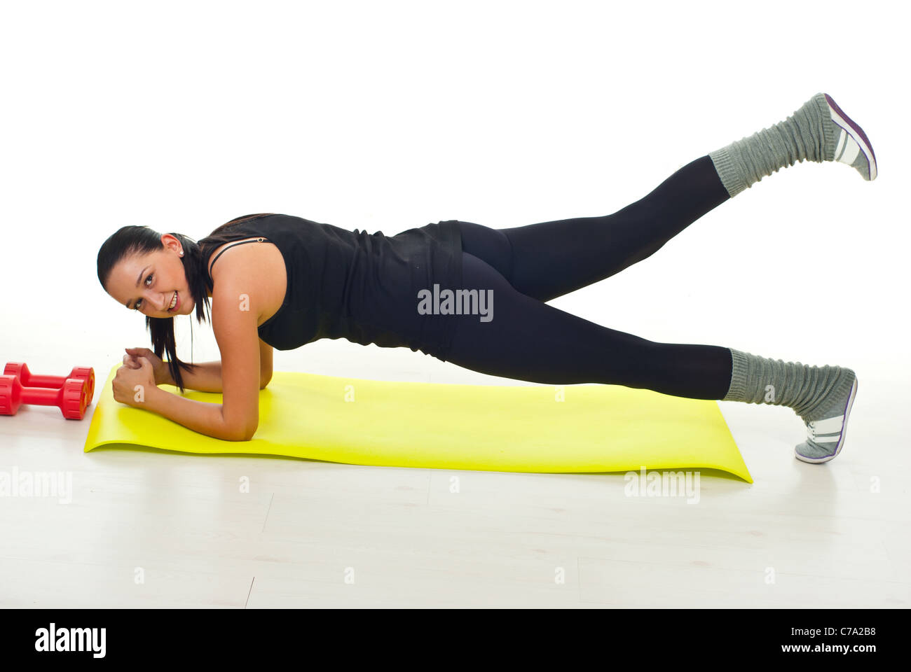 Young woman doing fitness exercises on yellow mat Stock Photo - Alamy