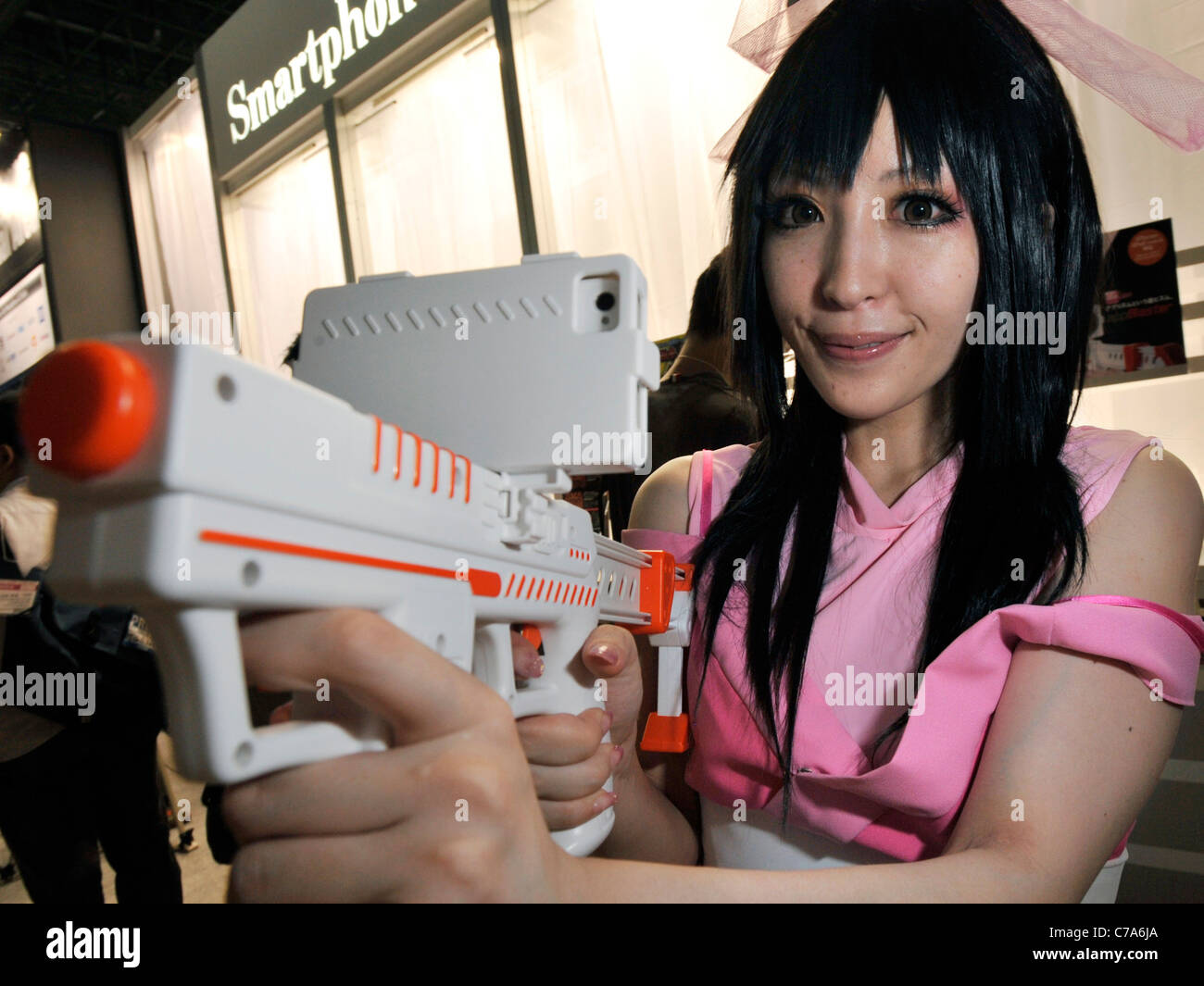 A booth demonstrator from WIZ inc. demonstrates the company's ...