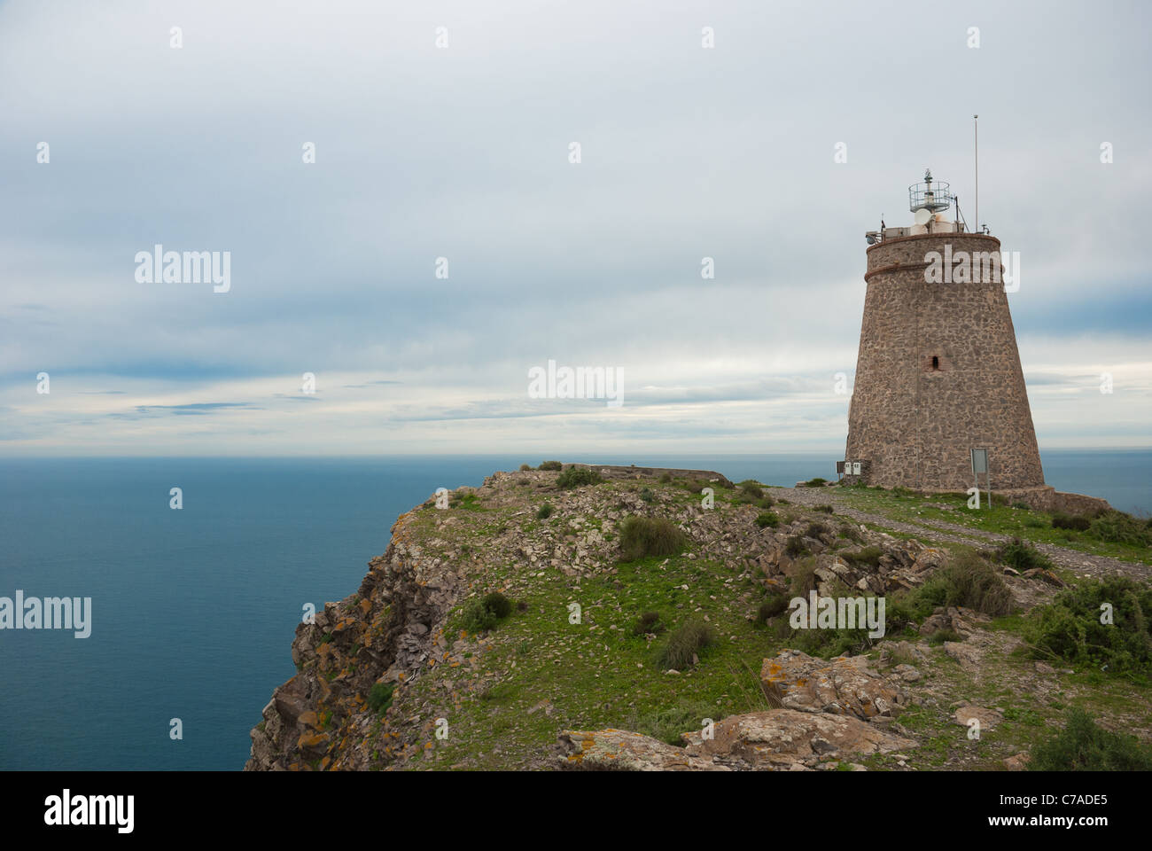 Old lighthouse overlooking the ocean from the top of a cliff Stock ...