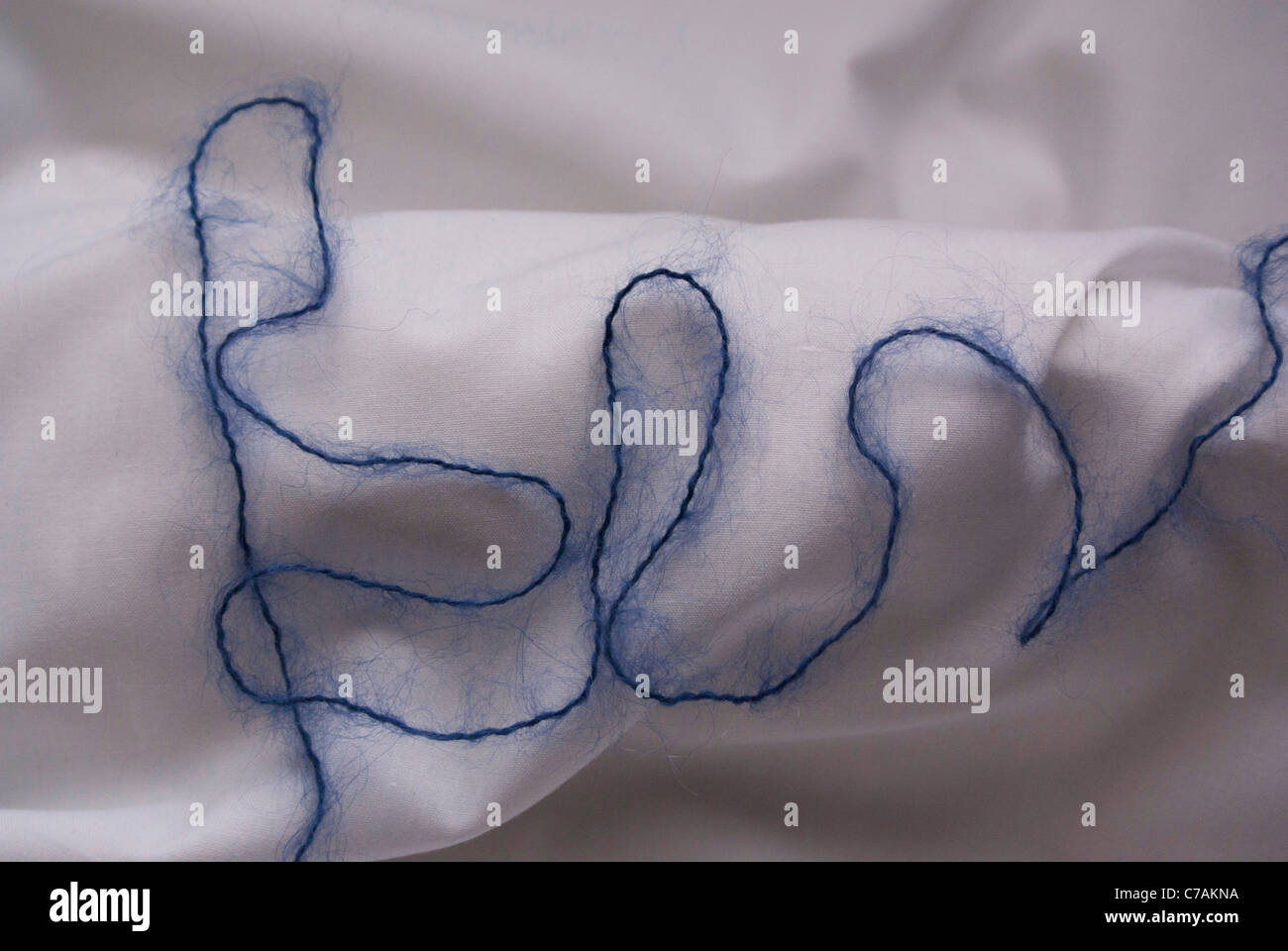 Strand of blue mohair wool on a white cloth background Stock Photo - Alamy