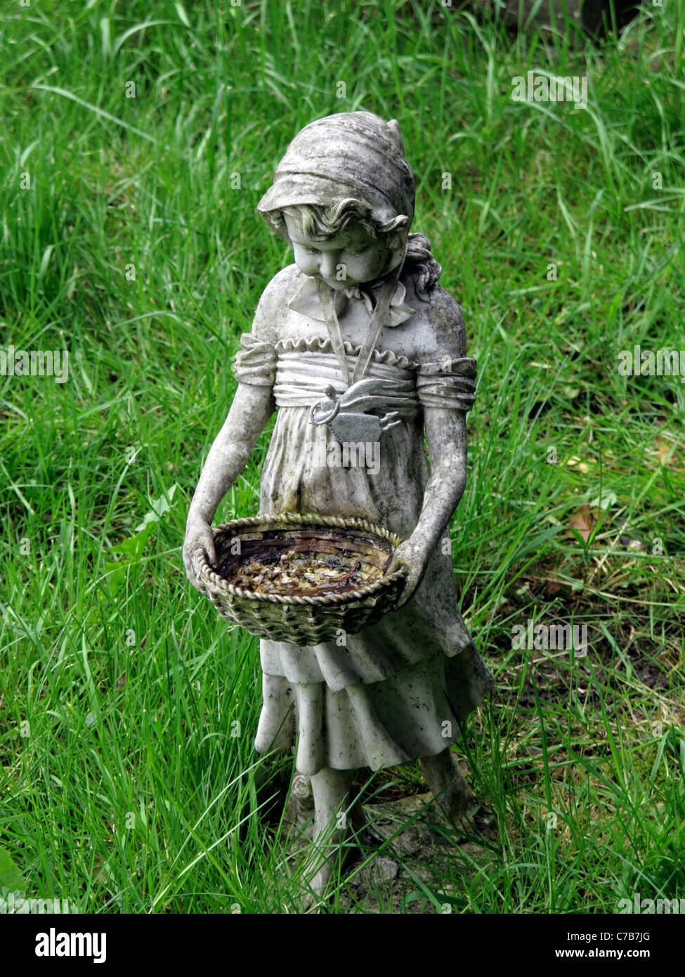 small statue of a little girl in church graveyard Derbyshire England ...