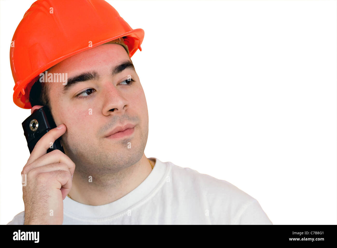 A construction worker talking on a cell phone with copyspace. Clipping ...