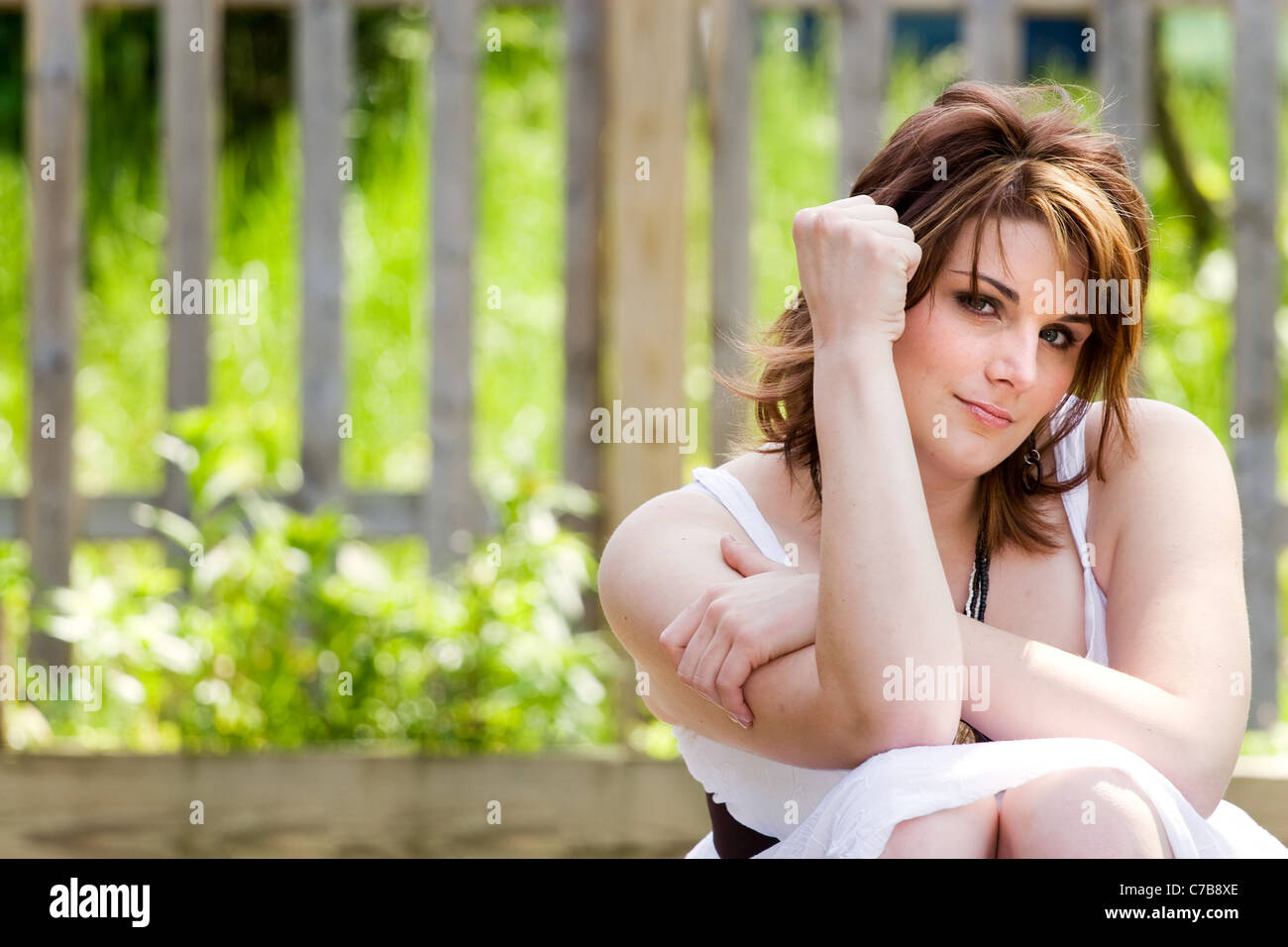 A confident young woman posing in a nice outdoor setting Stock Photo ...