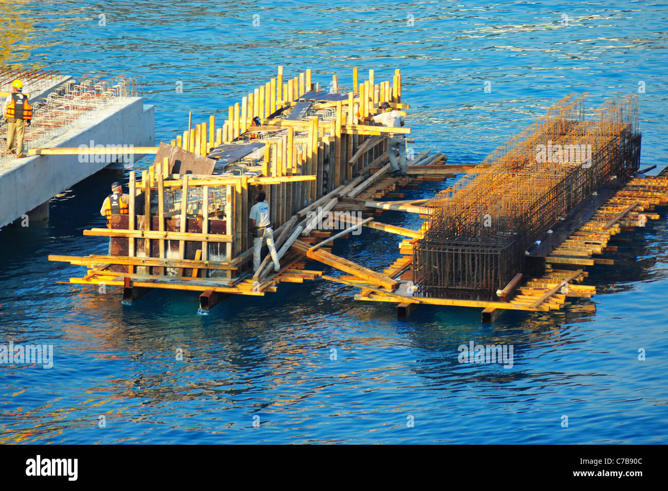 Men working on jetty Stock Photo - Alamy