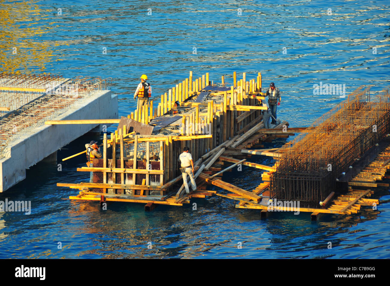 Men working on jetty Stock Photo - Alamy