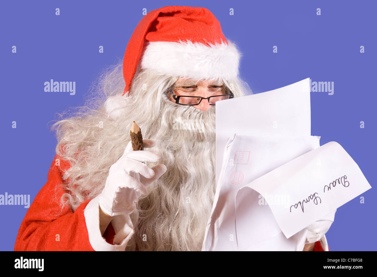 Santa Claus reads the letter Stock Photo - Alamy