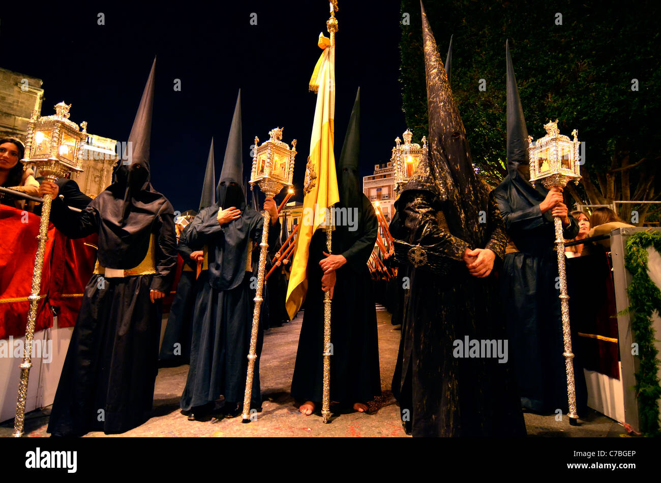 Nazarenos in black cowls on Palm Sunday at night, Semana Santa, Sevilla ...