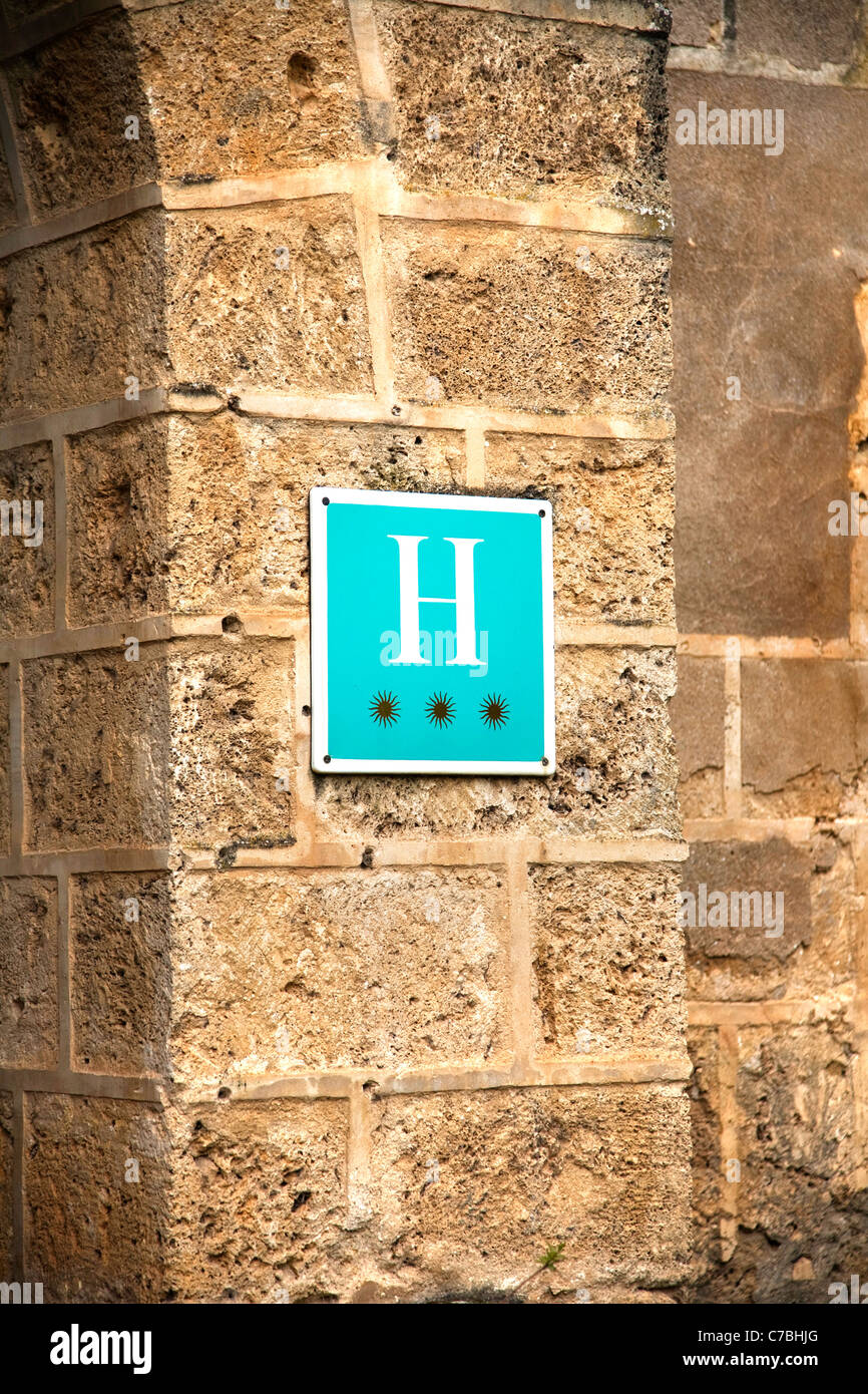 sign of a three stars hotel on a stone wall Stock Photo - Alamy