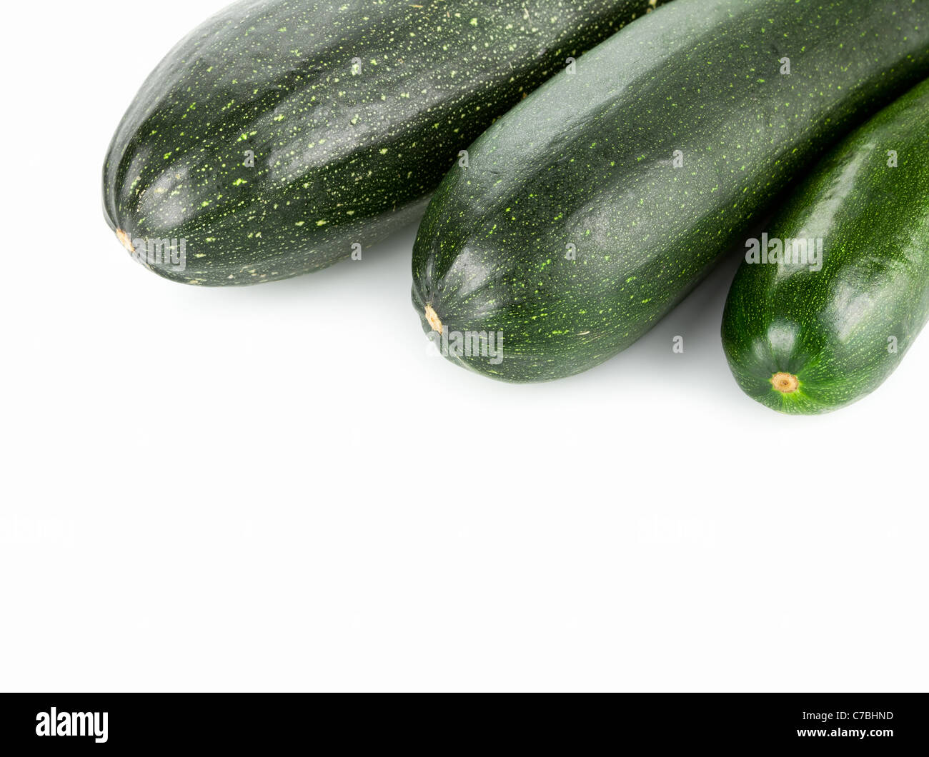 Three courgettes on white background with copy space Stock Photo - Alamy