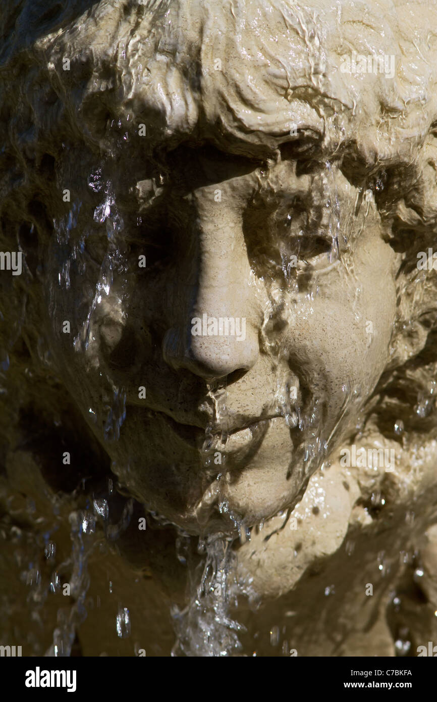 Statue of a man's head with water flowing over Stock Photo - Alamy