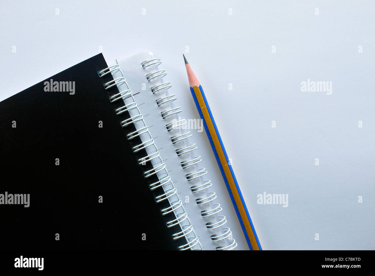 notebook with pencil on white background Stock Photo - Alamy