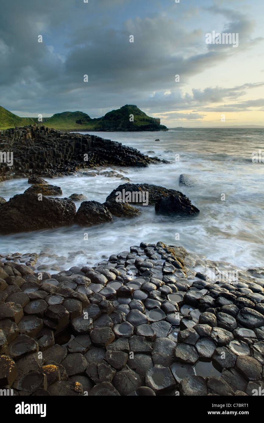 Waves splashing over basalt columns near sunset, Giant's Causeway ...