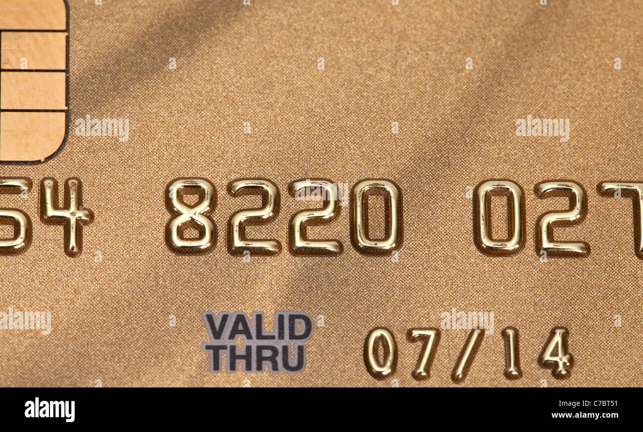 Macro view of golden debit (credit) card with numbers Stock Photo - Alamy