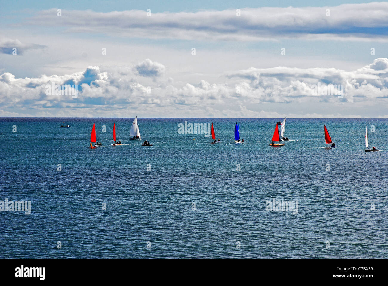 small sailing boats racing offshore from Lyme Regis Dorset England ...