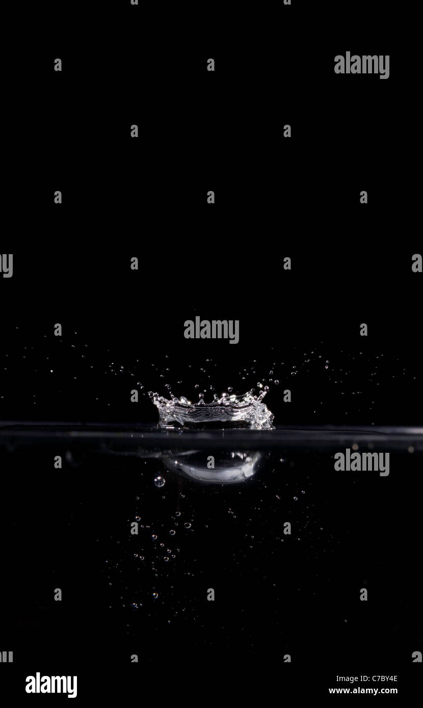 a splash of water above and below the water line with a black ...
