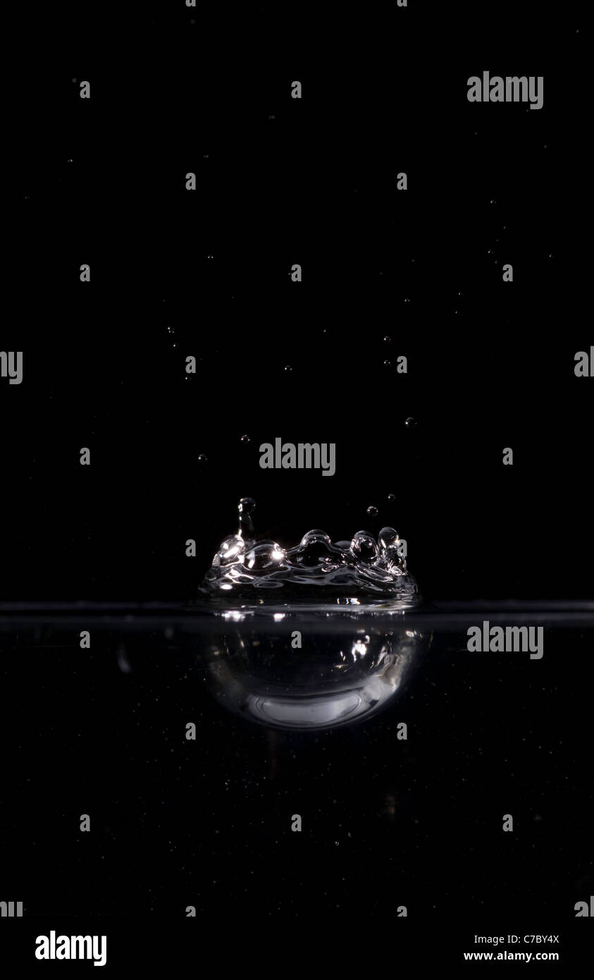 a splash of water above and below the water line with a black ...