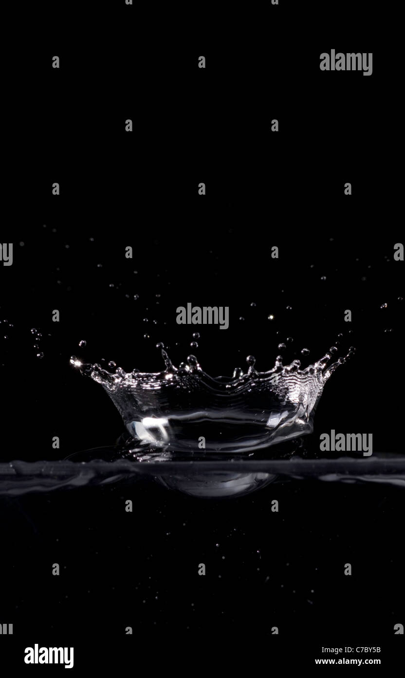 a splash of water above and below the water line with a black ...