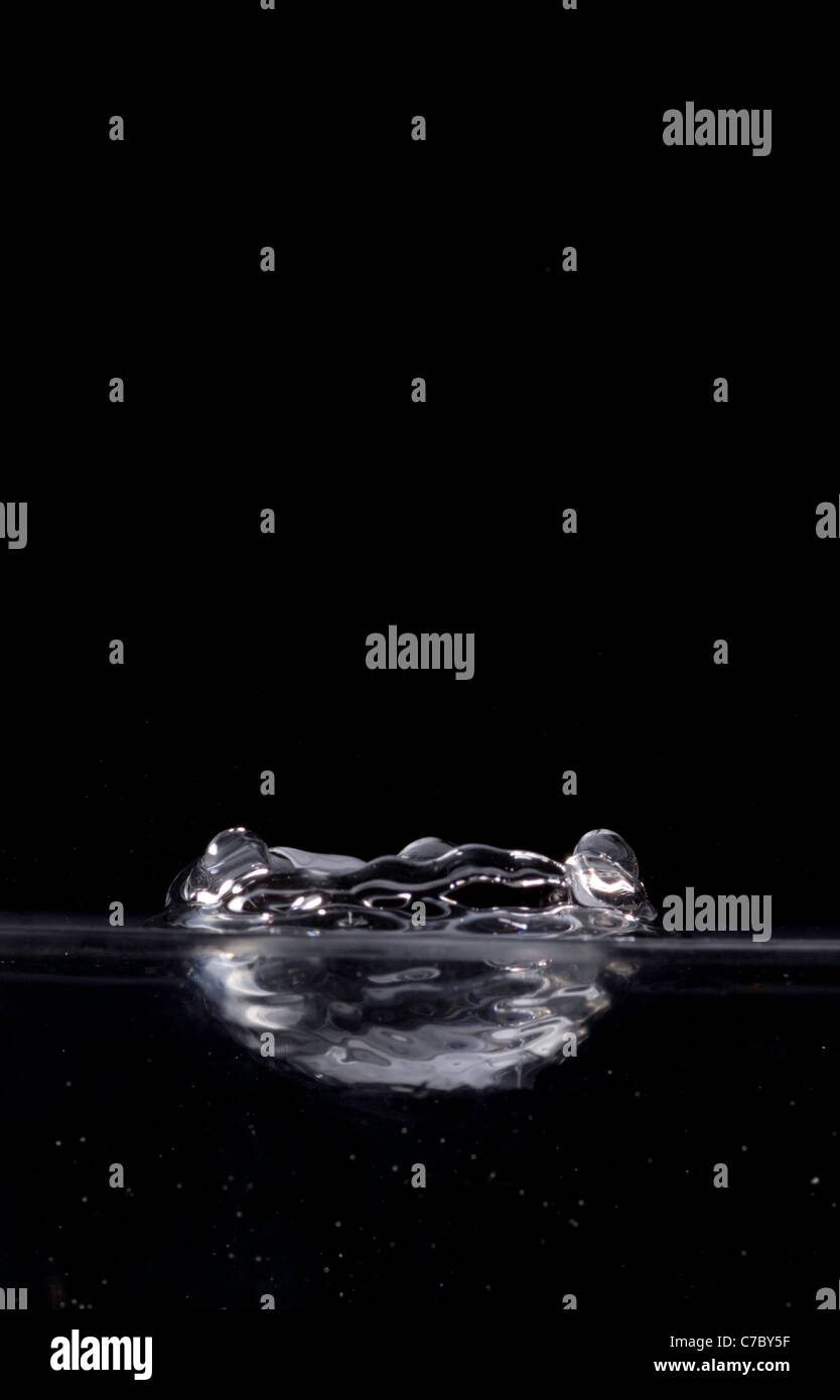 a splash of water above and below the water line with a black ...