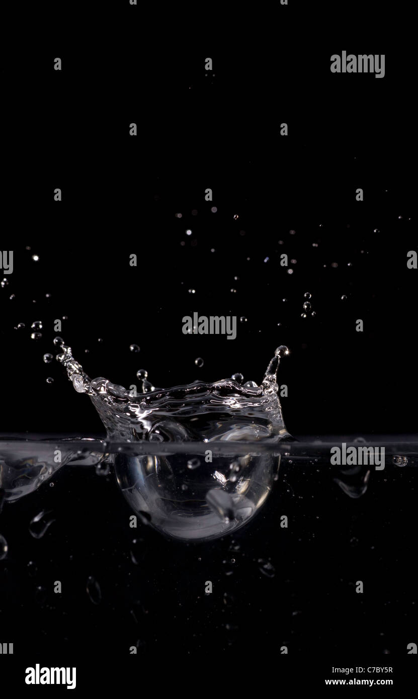 a splash of water above and below the water line with a black ...