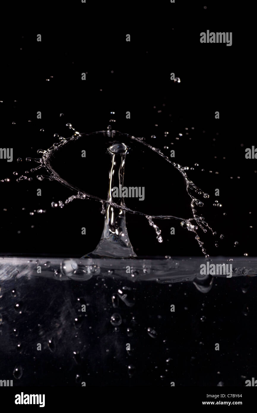 a splash of water above and below the water line with a black ...