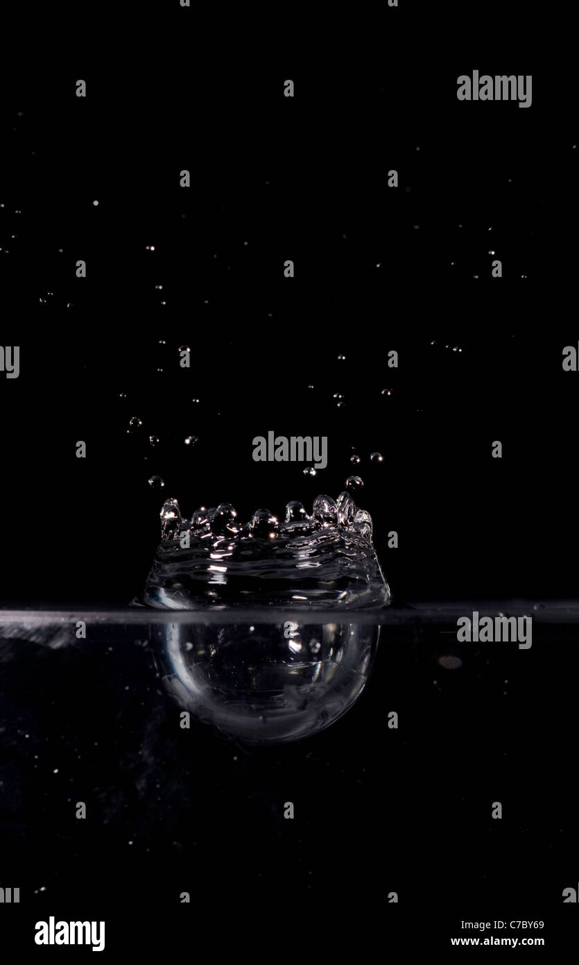 a splash of water above and below the water line with a black ...