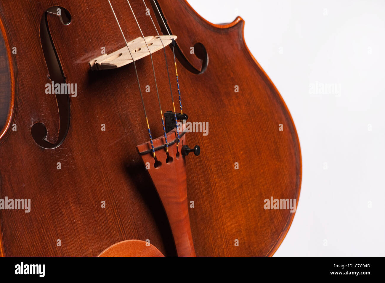 A antique violin viola up close isolated against a white background in ...