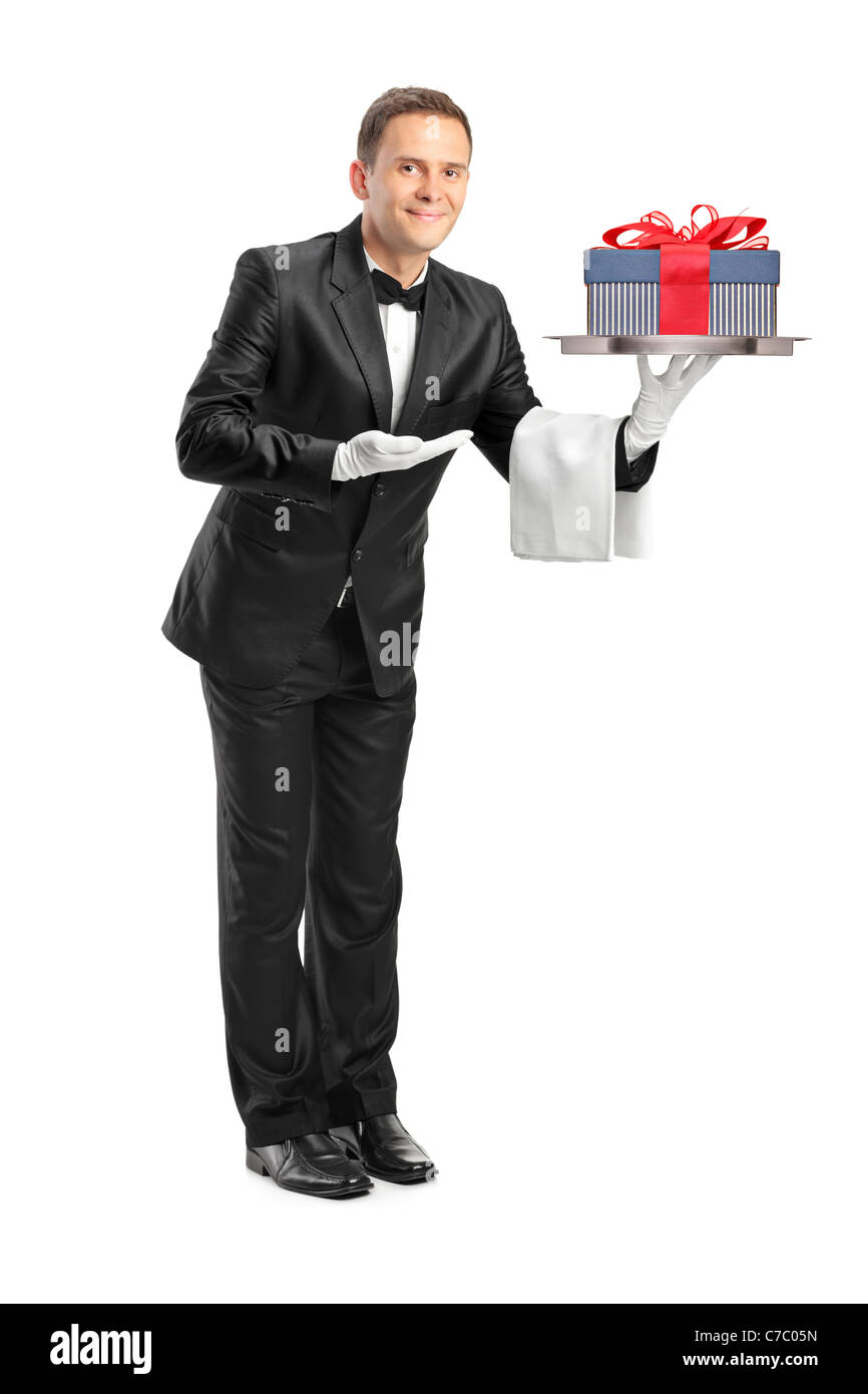 Full length portrait of a butler with bow tie holding a tray with a ...