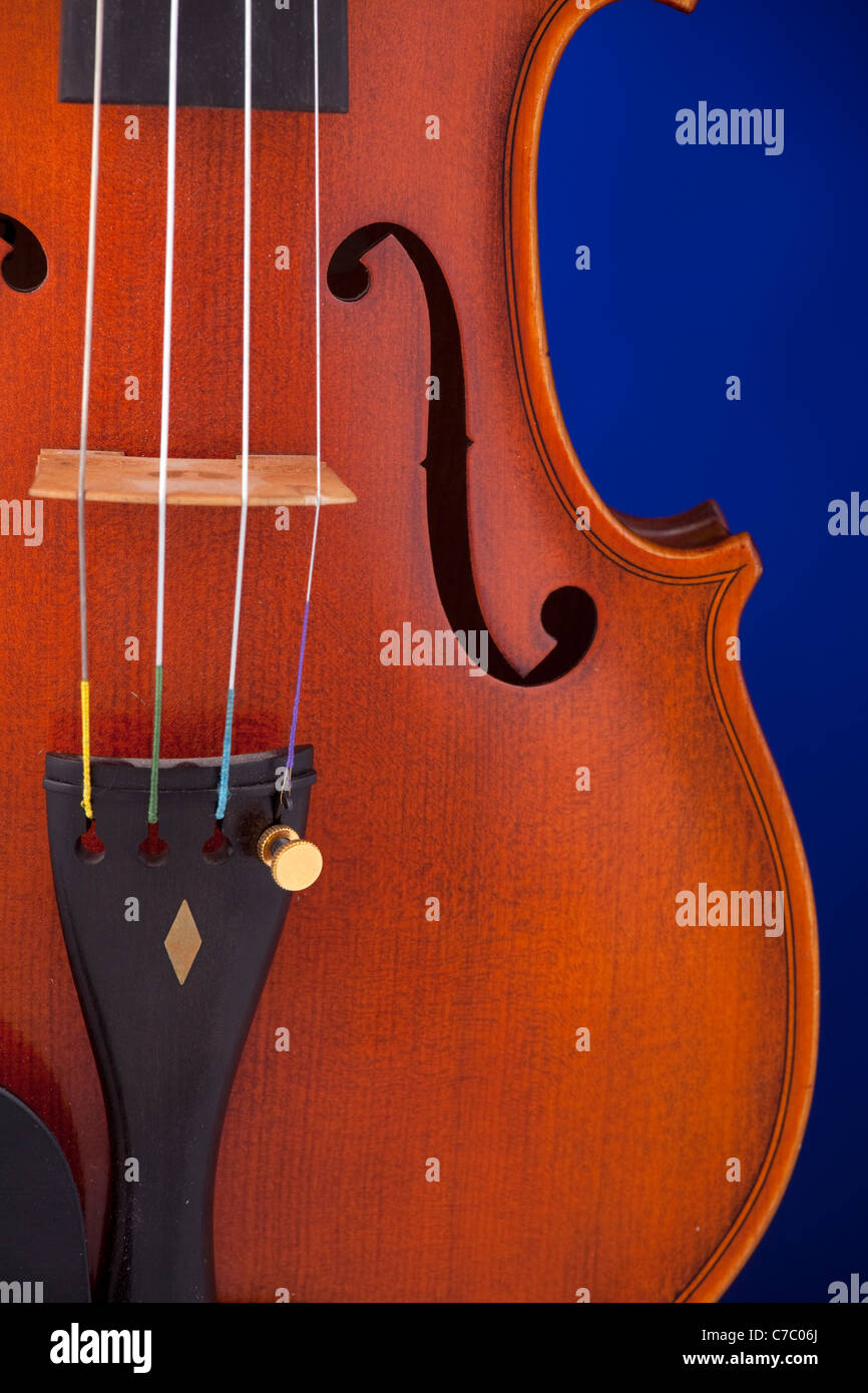A professional violin viola isolated against a blue background in the ...