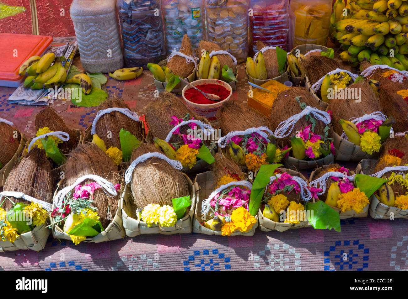 Small baskets with flowers and coconuts sold to Hindu pilgrims as ...