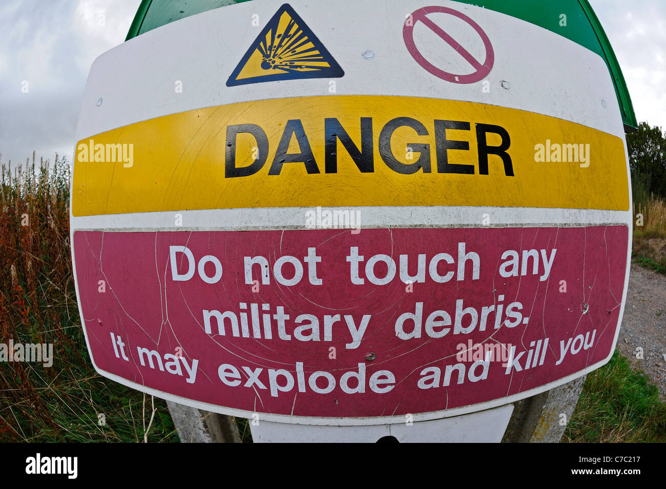 Warning sign informing not to touch military debris that it may explode ...