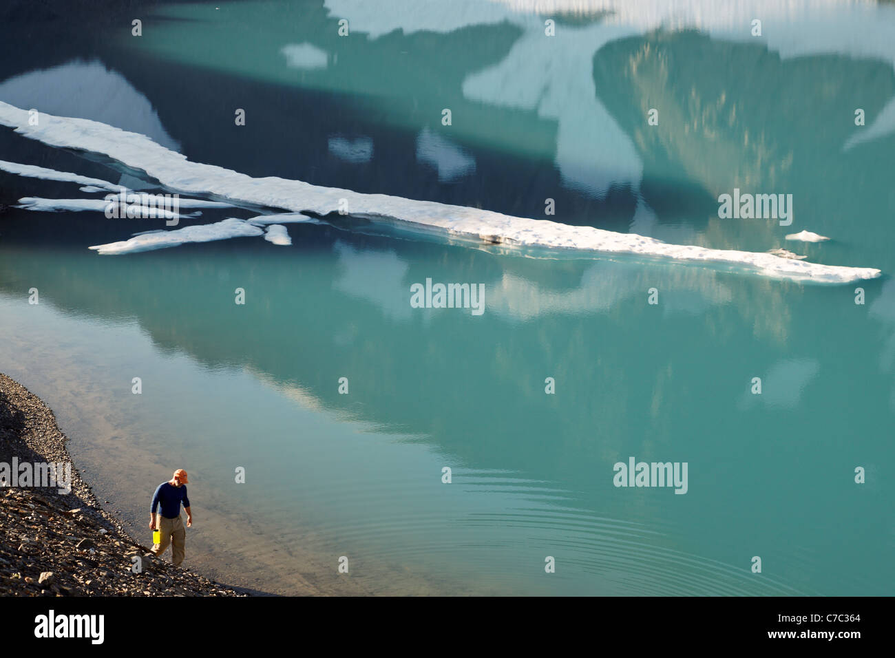 Backpacker on shore of alpine lake, upper Ferry Basin, Bailey Range ...