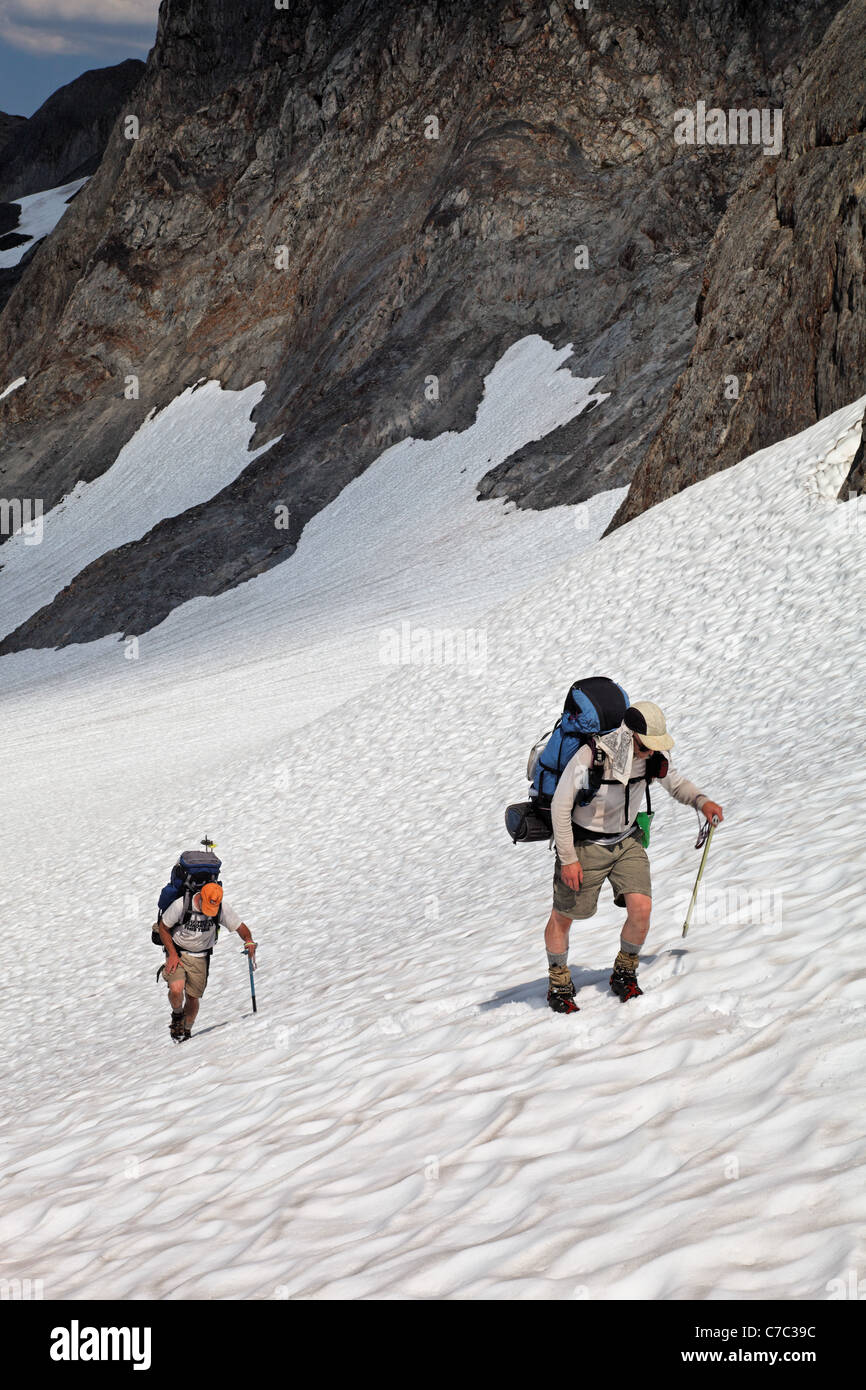 Backpackers climbing snow slope, Bailey Range Traverse, Olympic ...