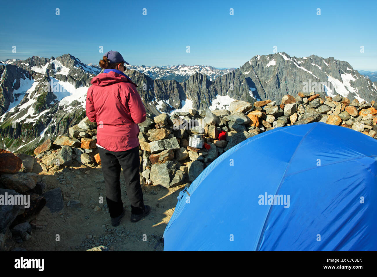 Woman at high alpine backcountry campsite on Sahale Arm, North Cascades ...
