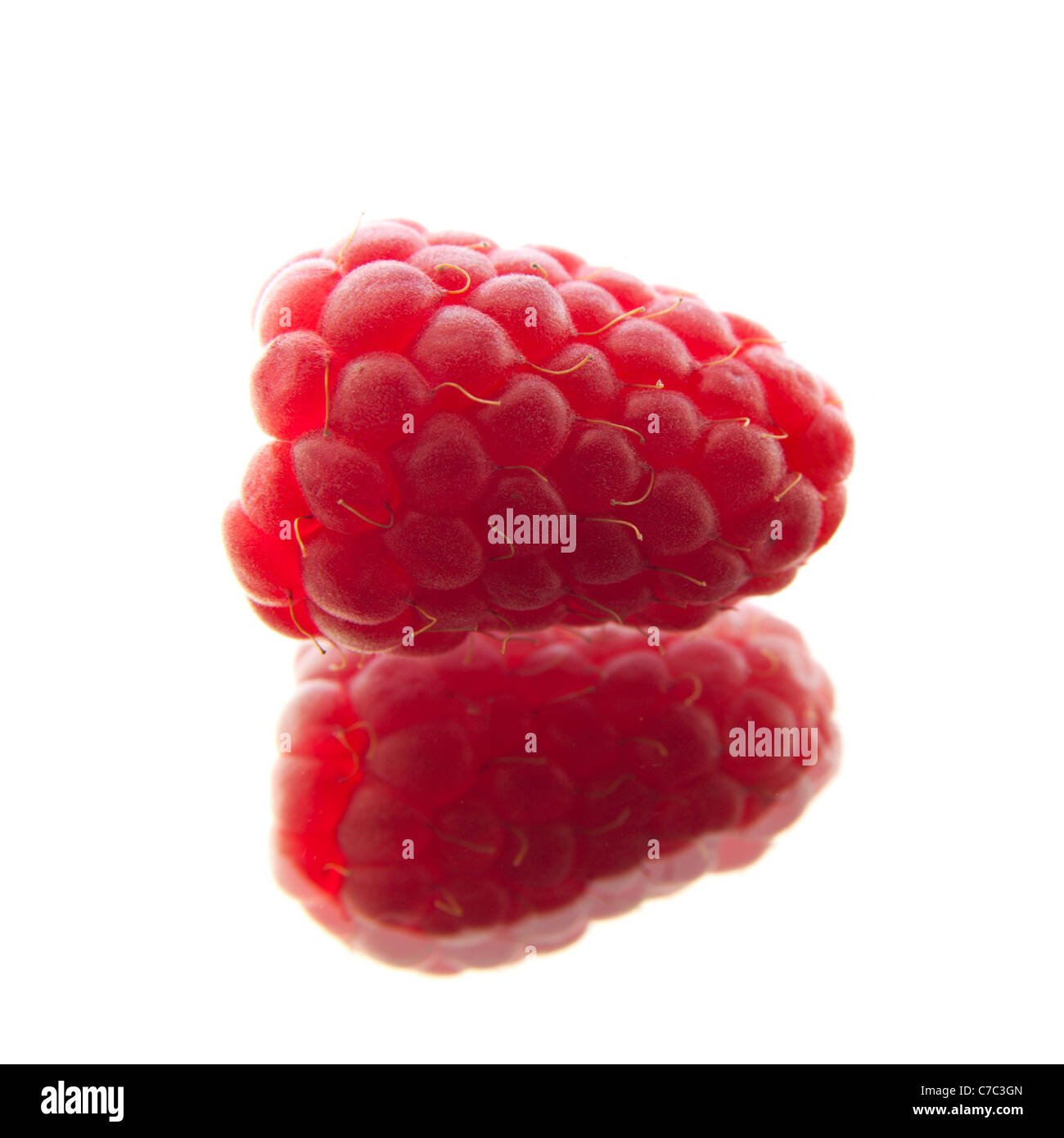 single raspberry isolated, on mirror Stock Photo - Alamy