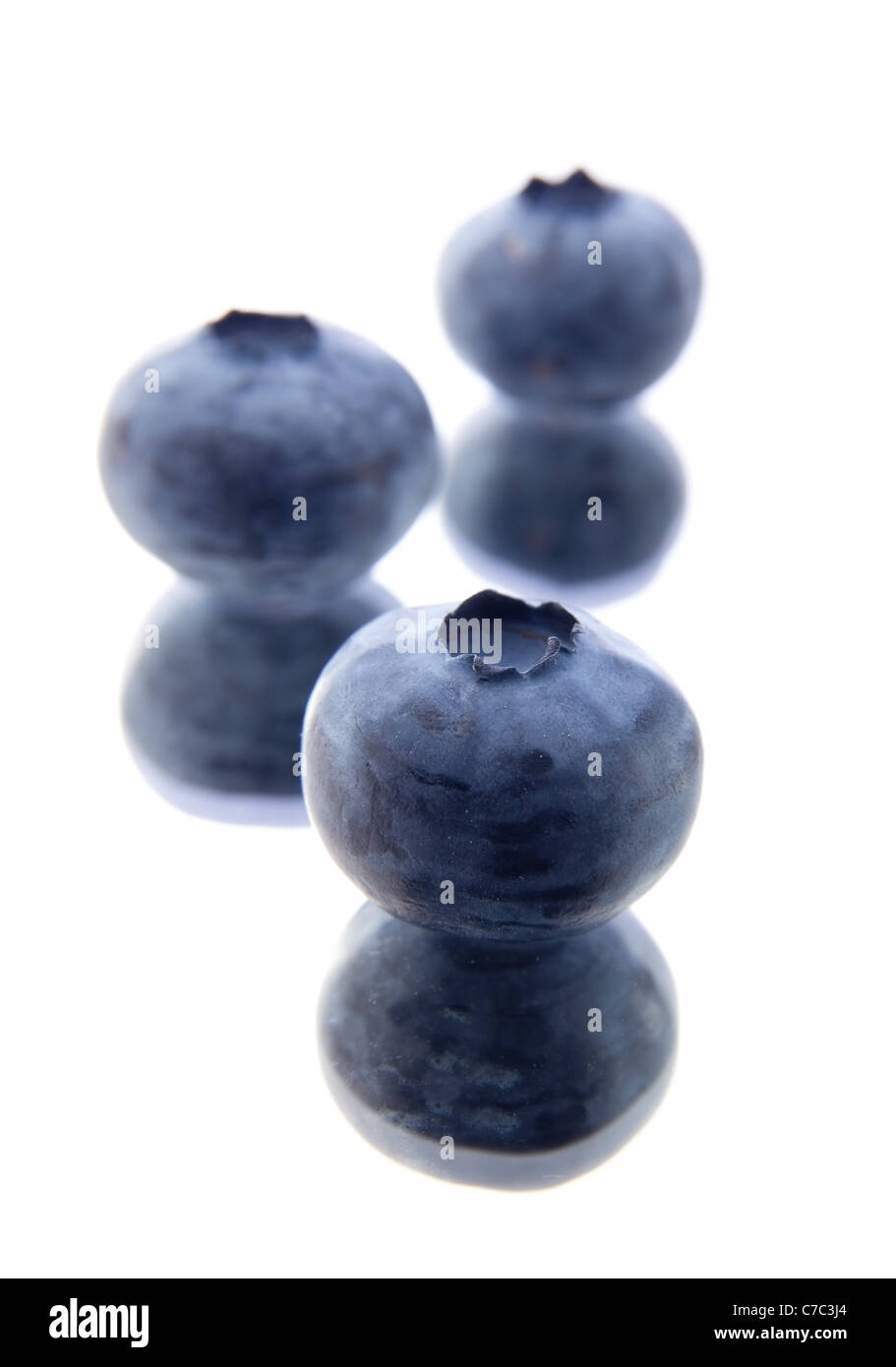 three blueberries on a mirror Stock Photo - Alamy