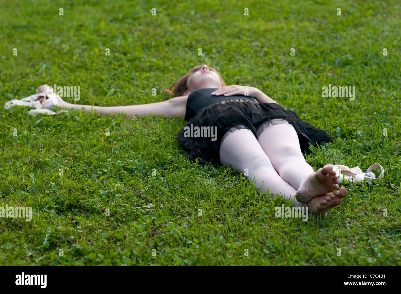 Ballerina resting on grass Stock Photo - Alamy