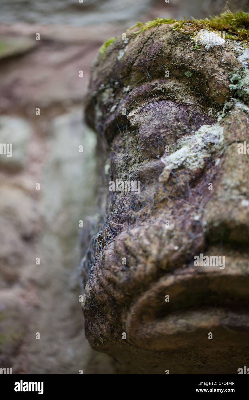 Half of a worn, ugly gargoyle face Stock Photo - Alamy